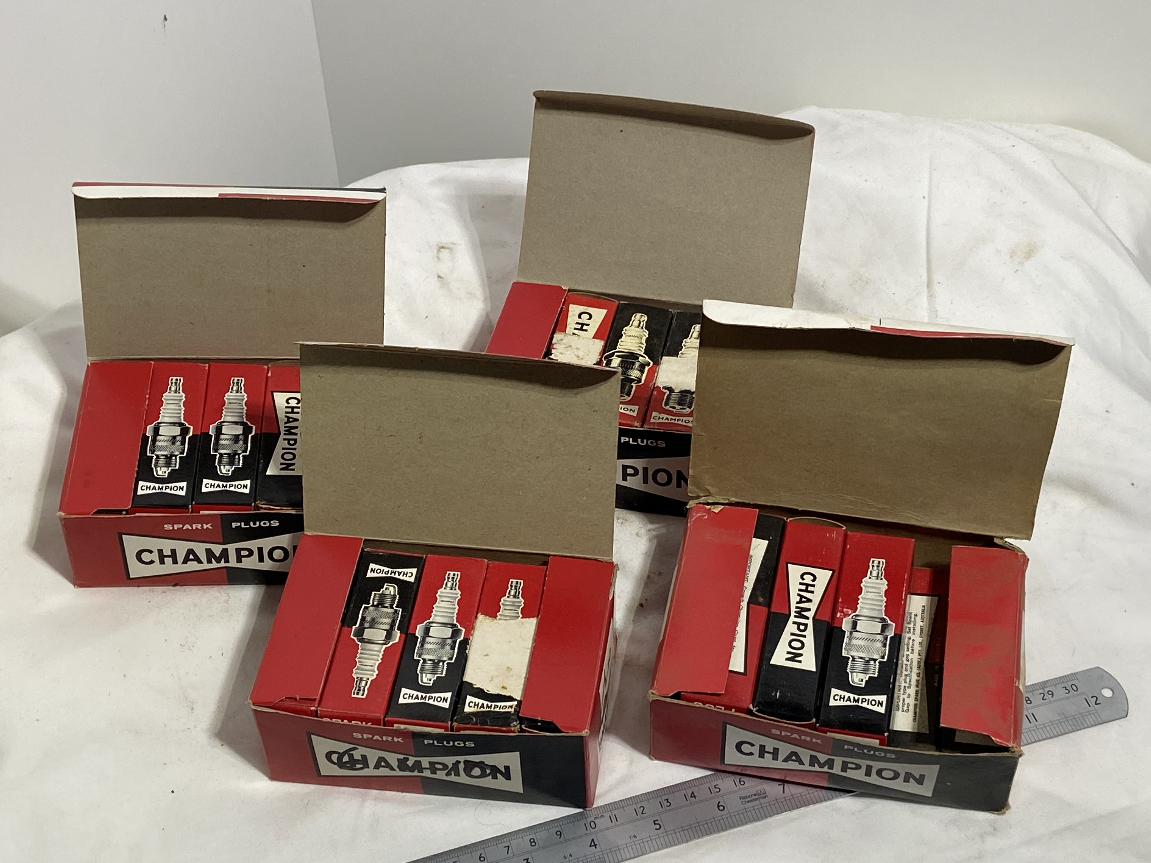 Lot 59 - 4x champion spark plug boxes with spark plugs | AuctionsPlus