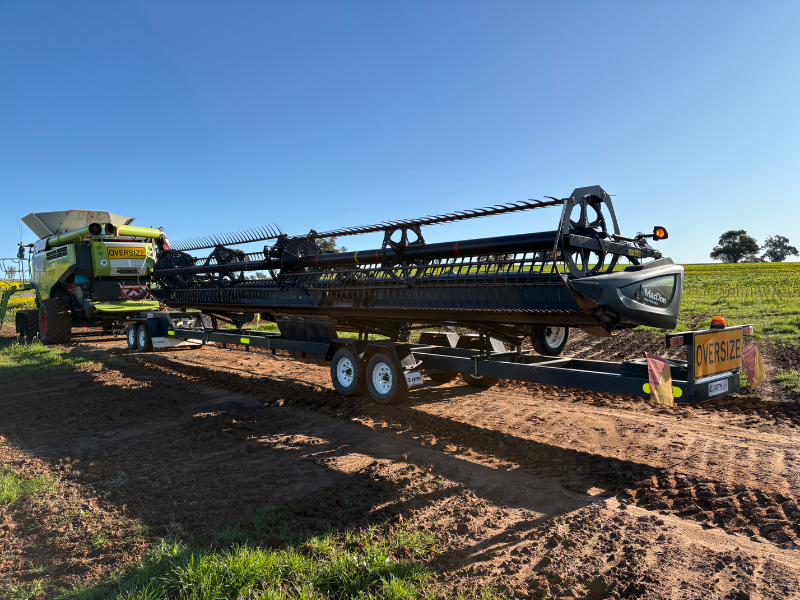 Lot 15 - Macdon D65 Draper Front on trailer | AuctionsPlus